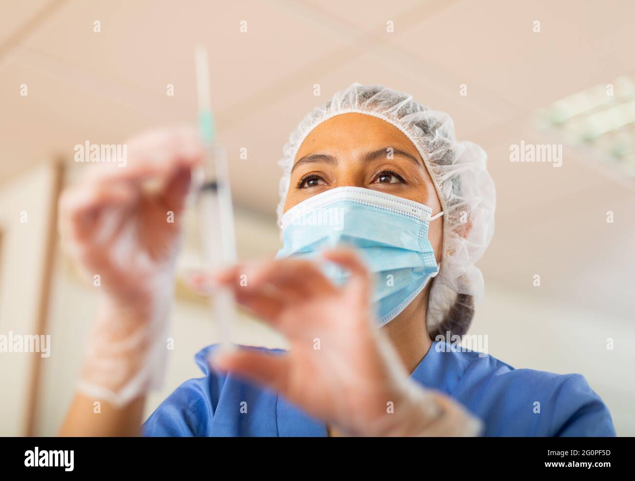Female nurse in mask prepared a syringe for injection Stock Photo - Alamy