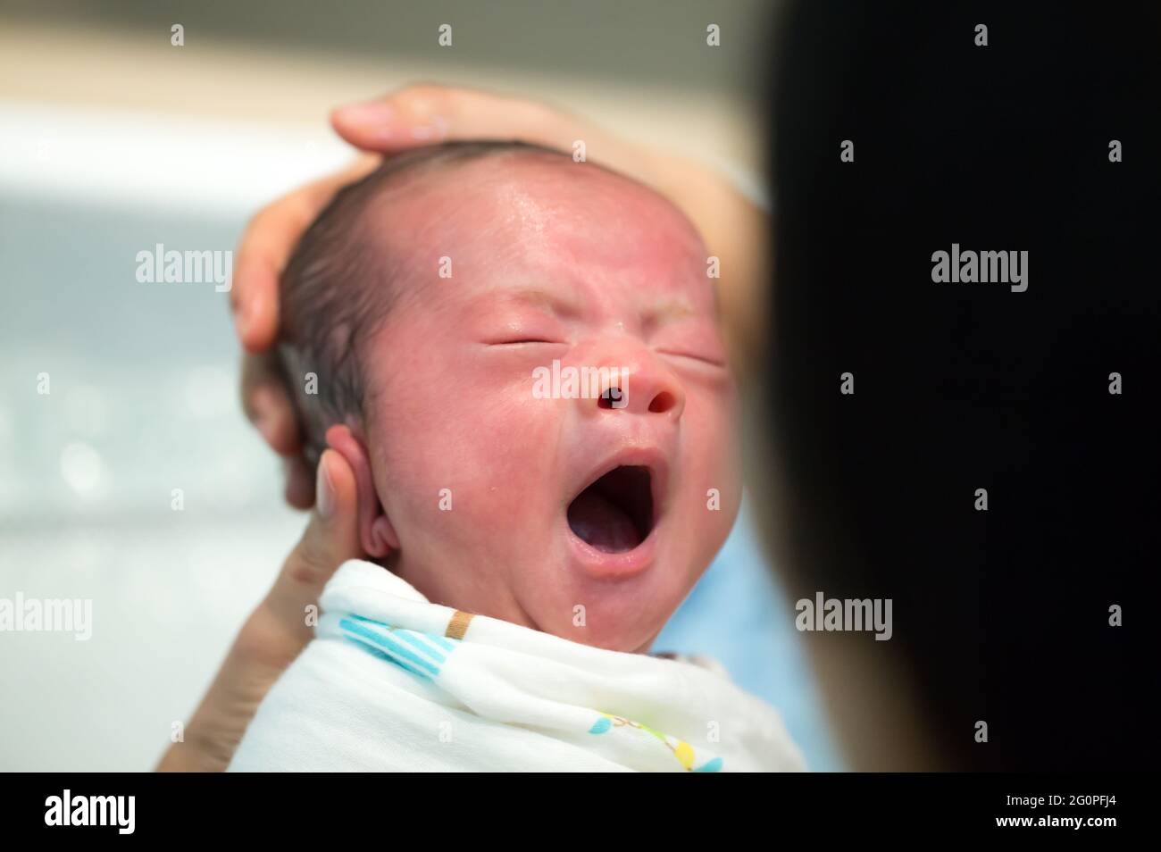 Asian newborn baby yawns, Two week old Stock Photo - Alamy