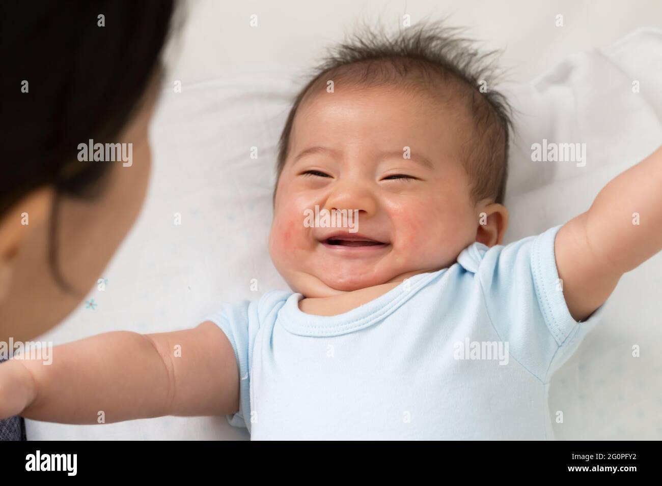 Happy baby play and smiling with mom Stock Photo - Alamy