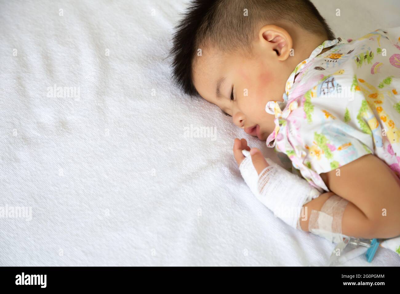 Asian baby boy sleeping on bed with infusion set at child department in ...