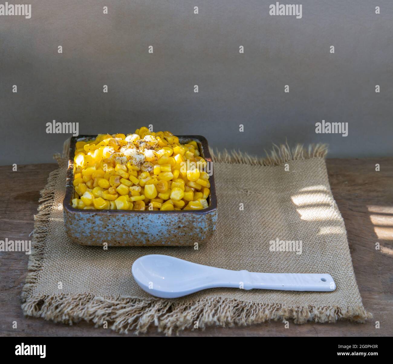 Fried sweet corn with a knob of butter and seasonings Sprinkle with ...