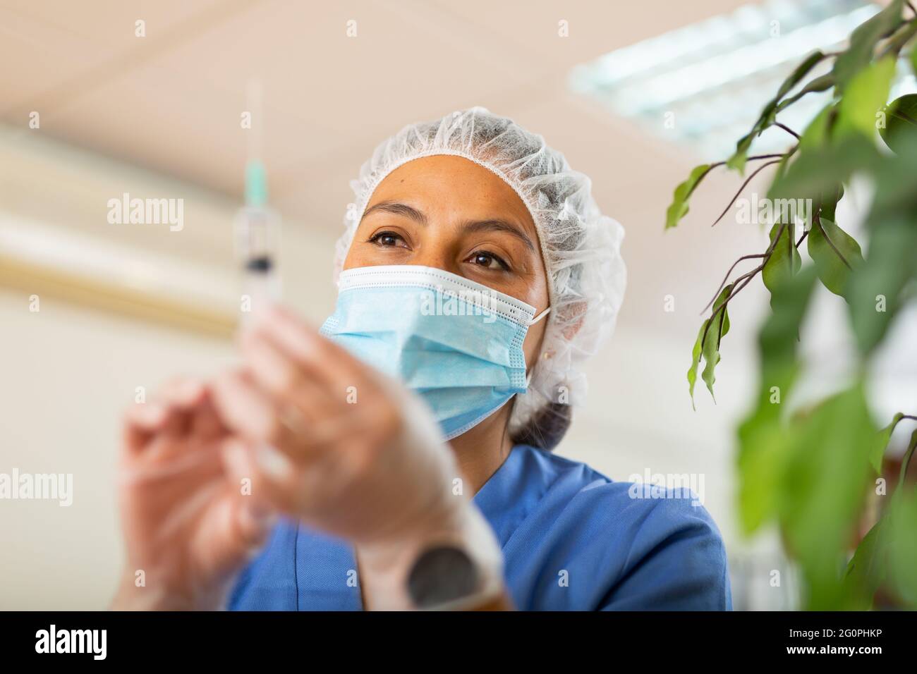 Confident woman doctor holding syringe for injection Stock Photo - Alamy