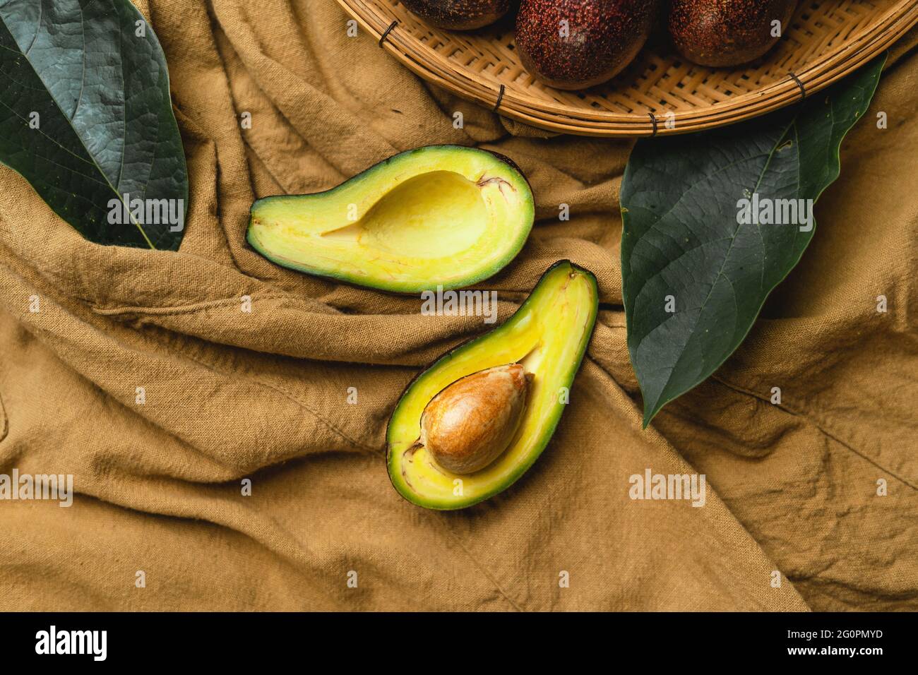 avocado in wooden tray healthy food brown background Stock Photo - Alamy