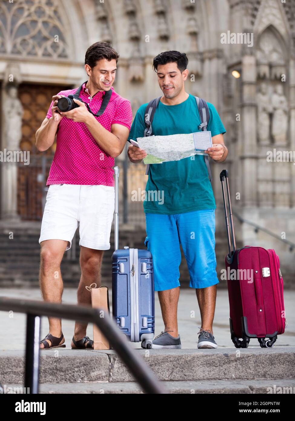 Tourists are photographing and searching way in map Stock Photo - Alamy