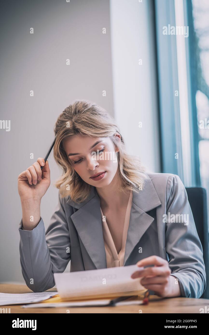 Focused woman reading document in hi-res stock photography and images ...
