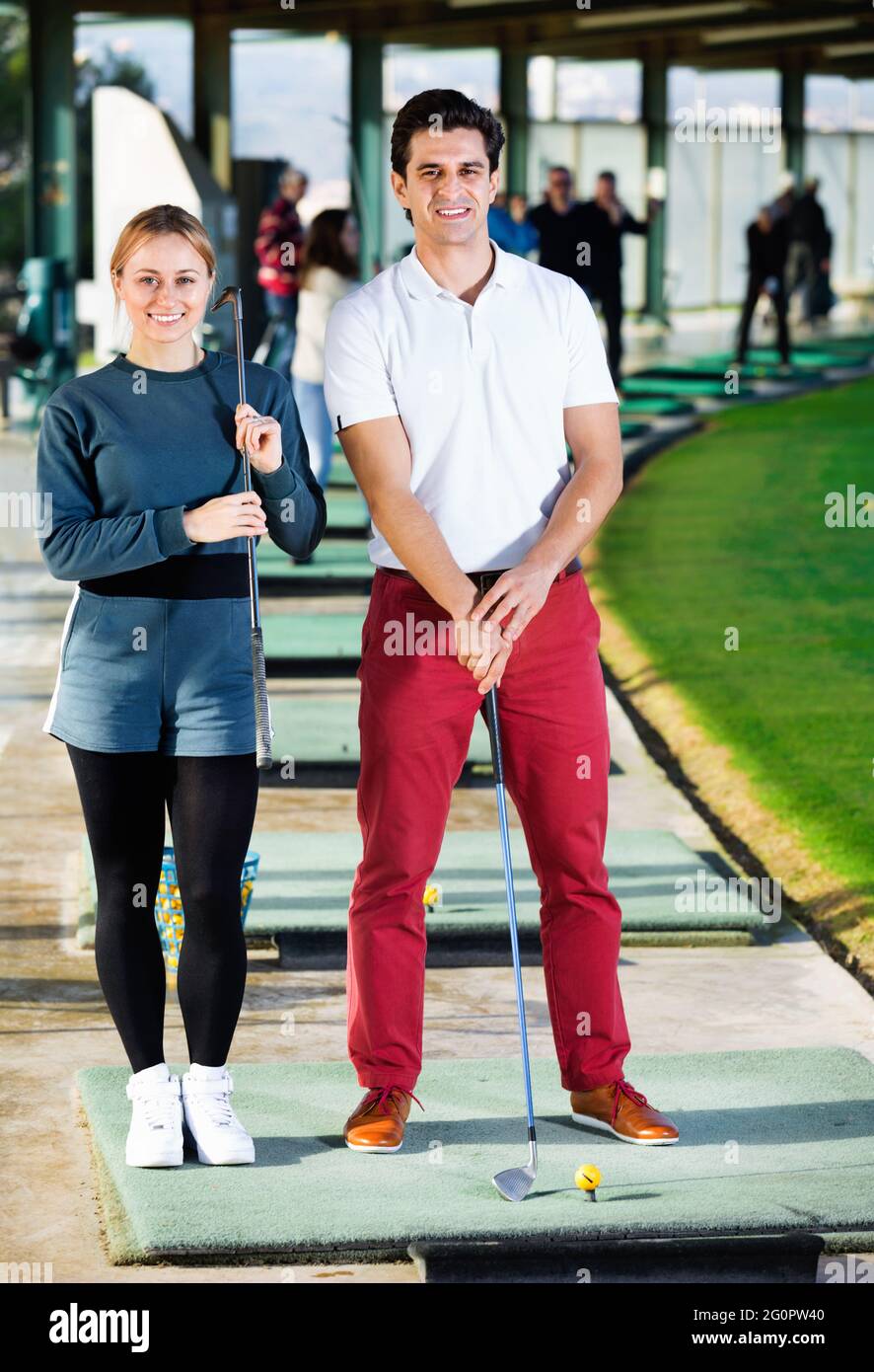 Man and woman golf partners ready to enjoy game Stock Photo - Alamy
