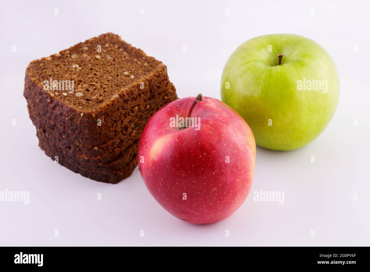 sliced rye bread on a white background with green and red apples Stock ...