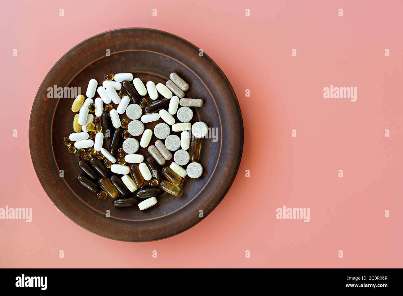 topview of multivitamin pills on a clay plate. dietary concept. dietary ...