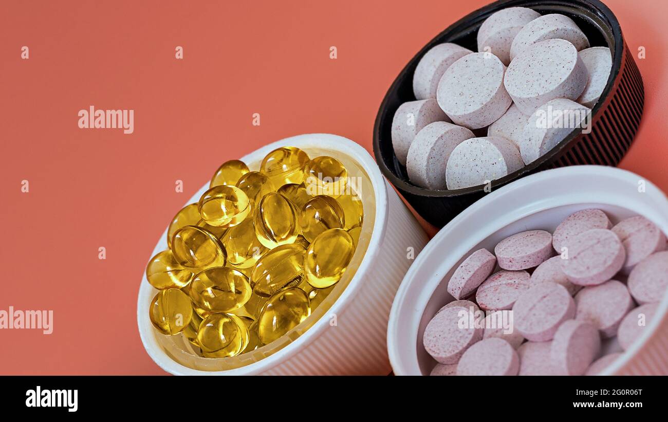 close-up of multivitamin biologically active supplements on coral ...