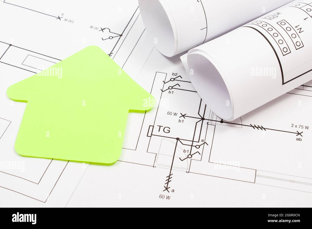 House shape made of paper and diagrams of plan with electrical ...