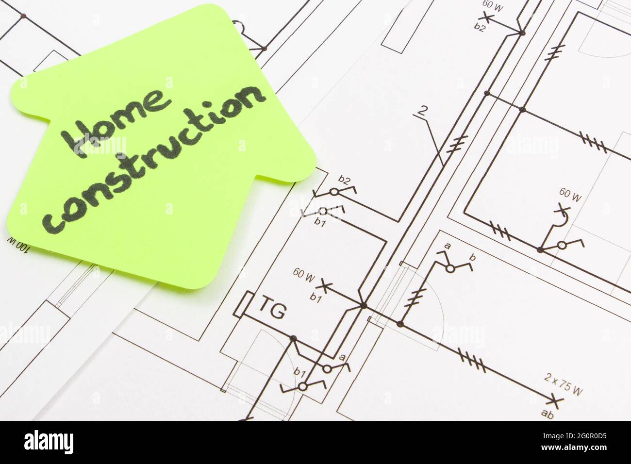 House shape made of paper with inscription home construction and ...