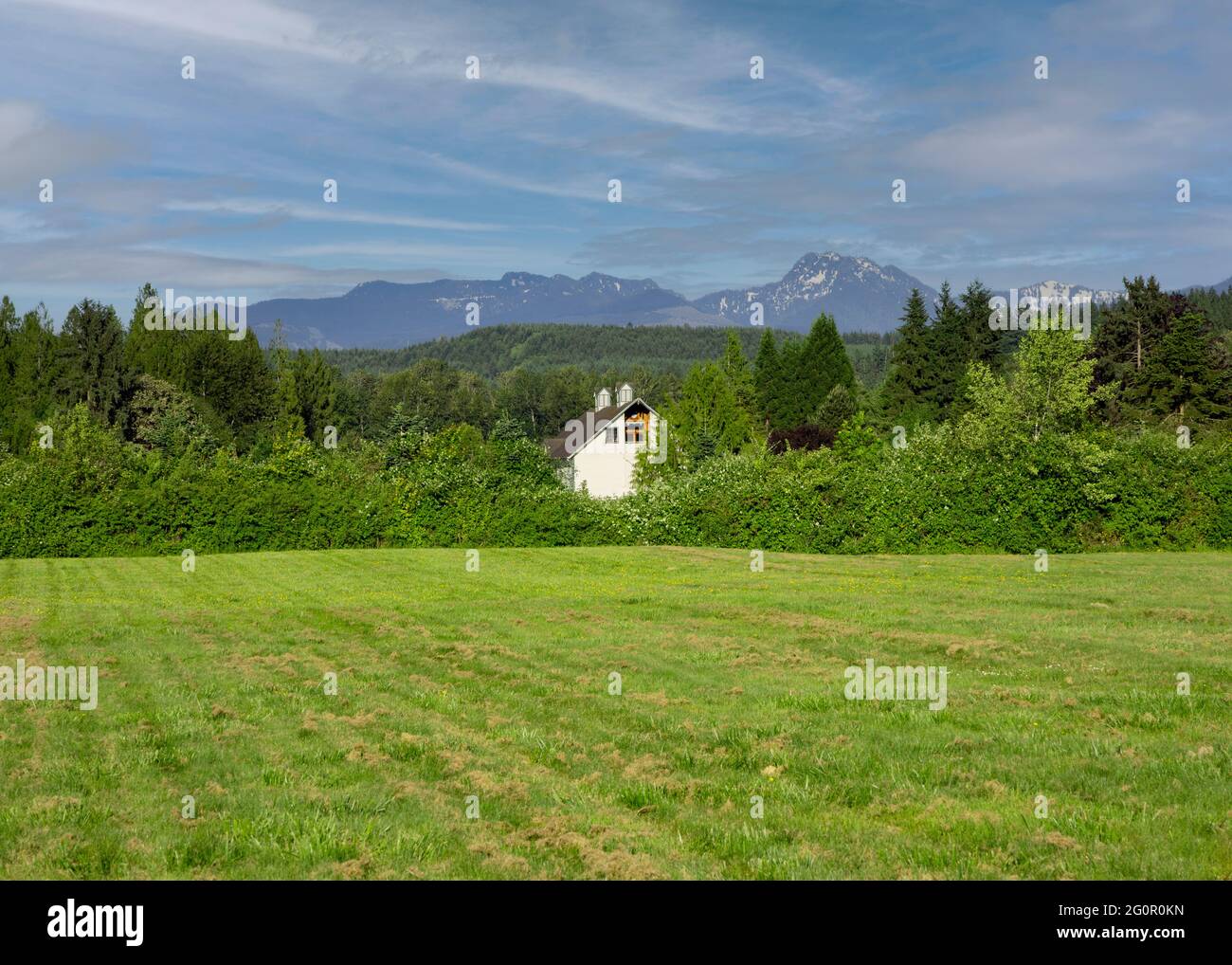 Farm style home with the cascade mountains in the background Stock ...