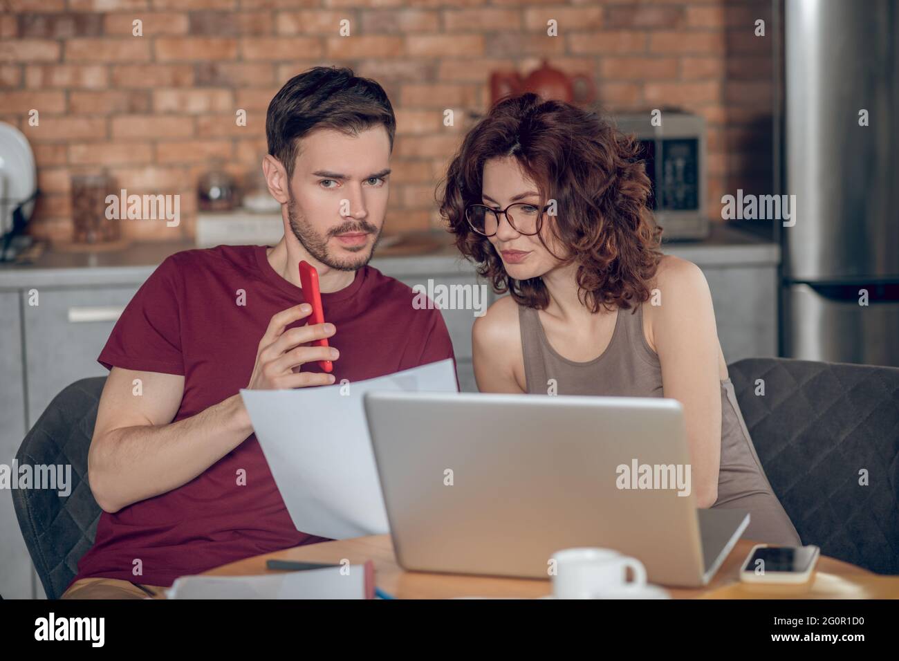 Two people working on project and looking busy Stock Photo - Alamy