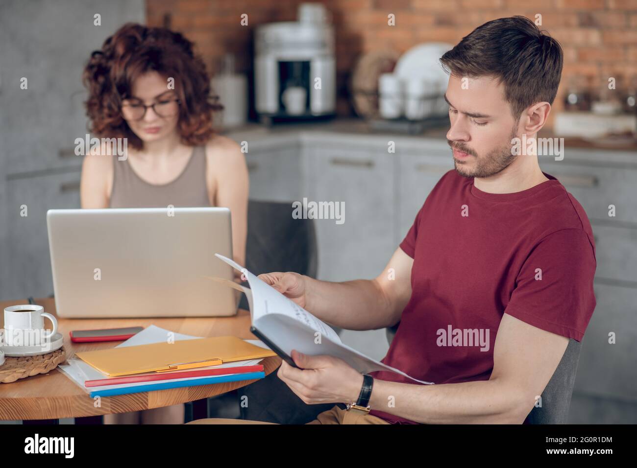 Two people working on project and looking busy Stock Photo - Alamy