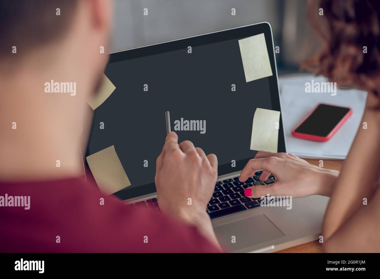 Team members working on a project together Stock Photo - Alamy