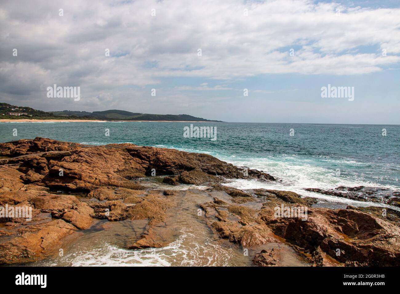 Rock pools at the beach with bay and sea beyond Stock Photo - Alamy