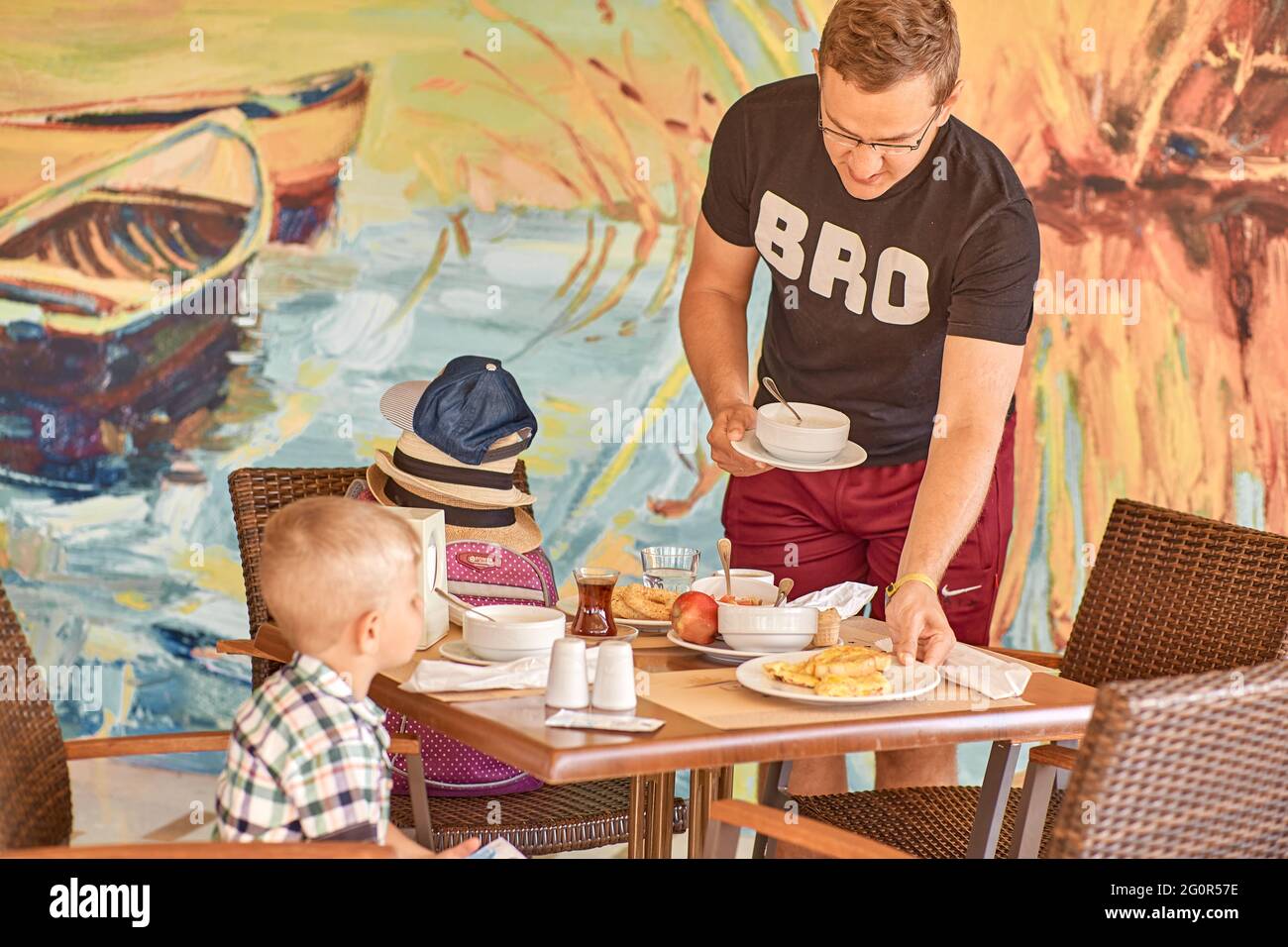 Kemer, Turkey - May, 21: Father and son in a restaurant having ...