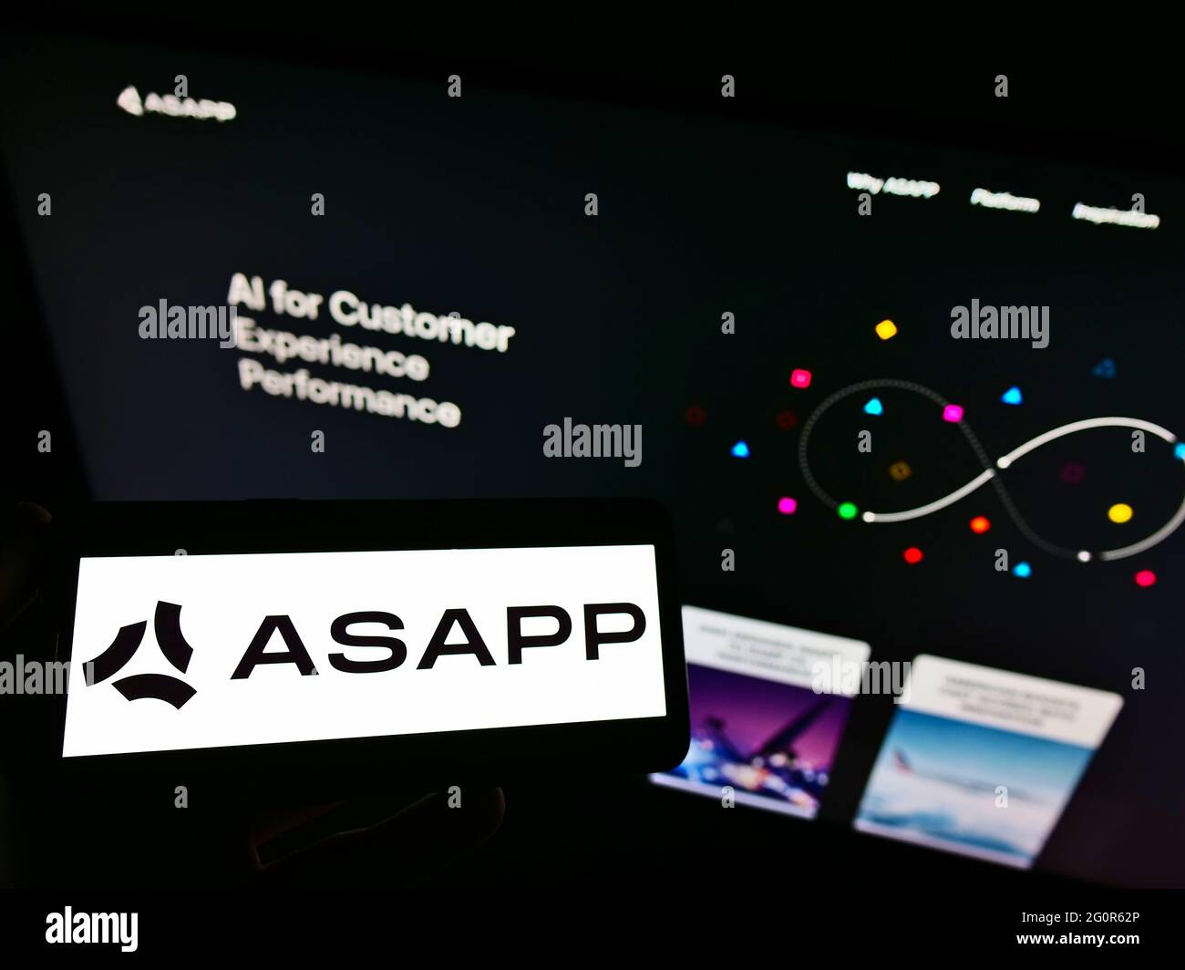 Person holding mobile phone with logo of American artificial ...