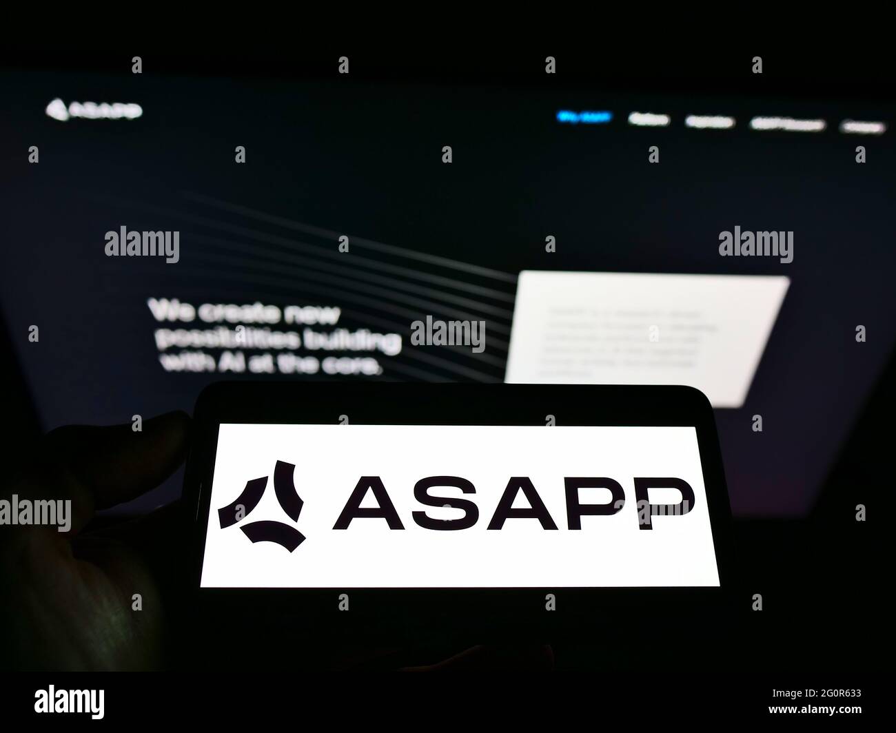 Person holding cellphone with logo of US artificial intelligence ...