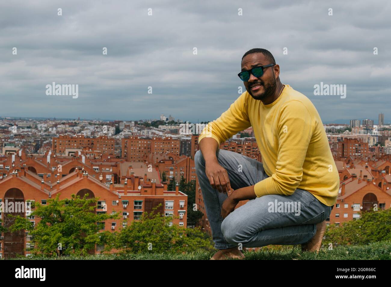 Black man looking at the horizon in a park with glasses Stock Photo - Alamy