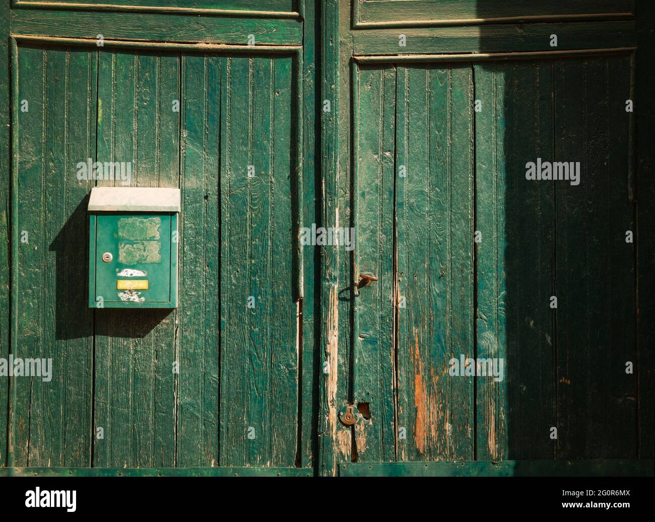 Green mailbox on a green wood door Stock Photo - Alamy
