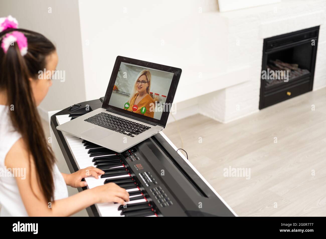 Homeschool little young kid girl learning piano from computer ...