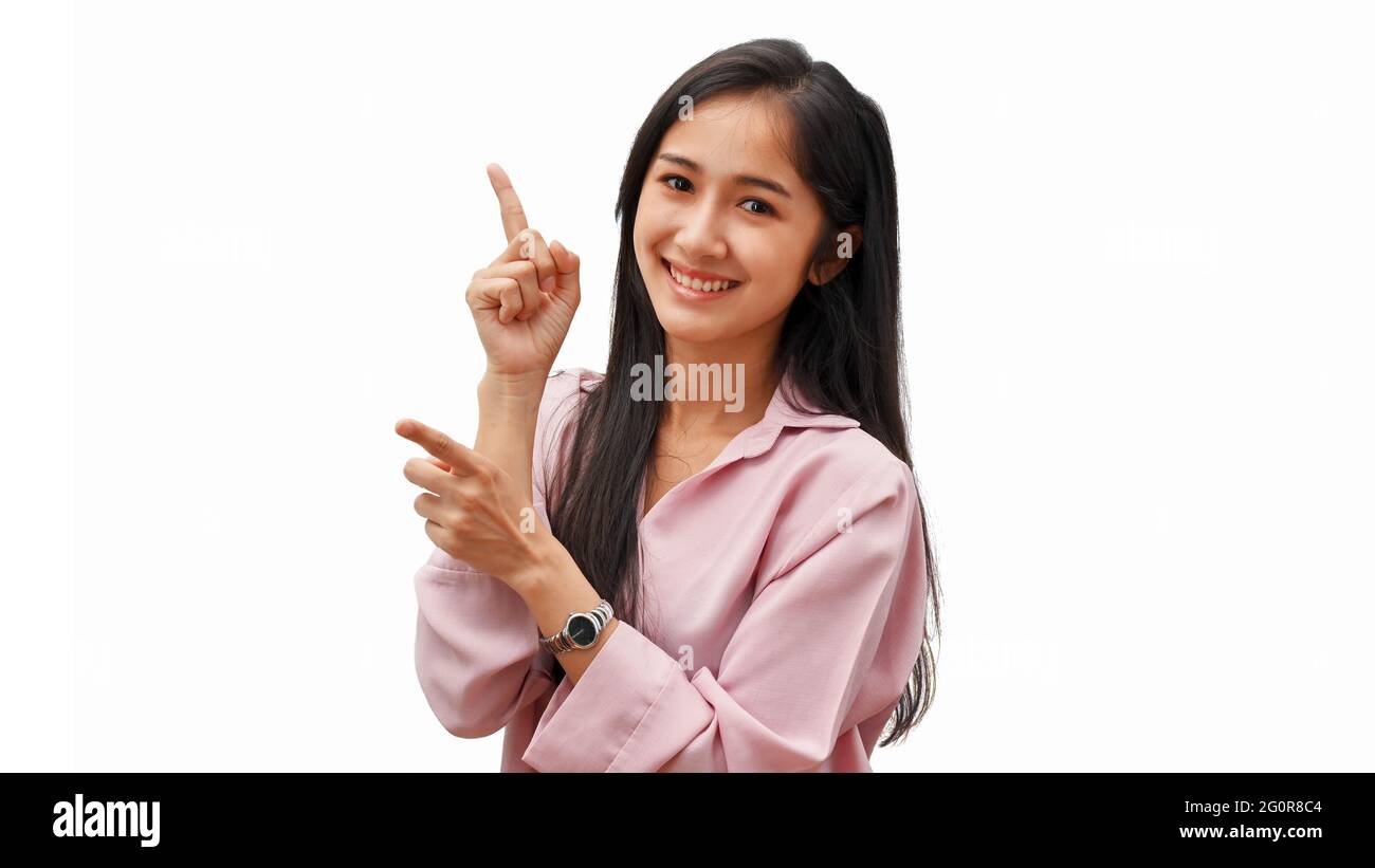 Portrait of young female gesturing with two index finger pointing ...