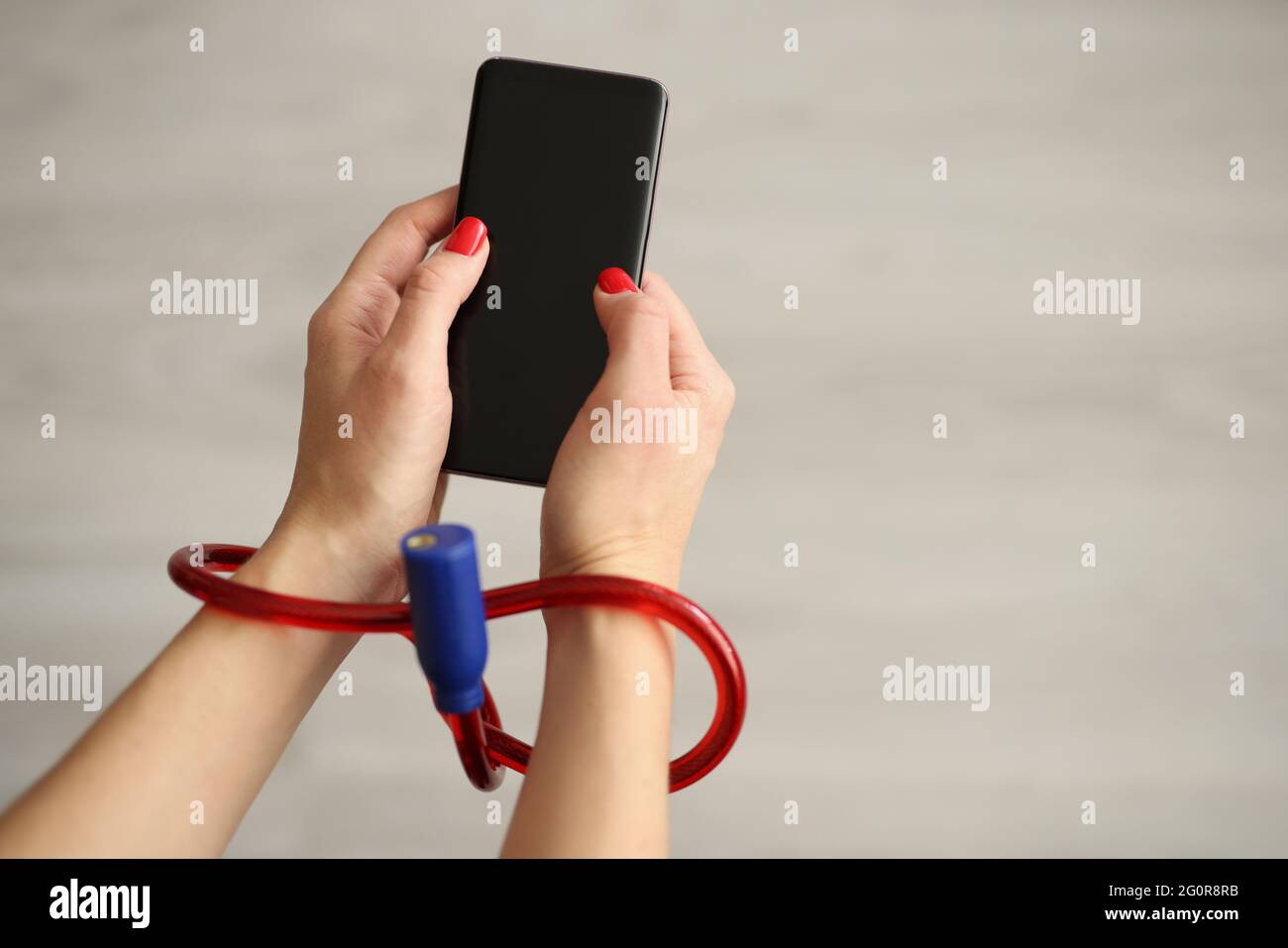 Woman with tied hands holding mobile phone closeup Stock Photo - Alamy