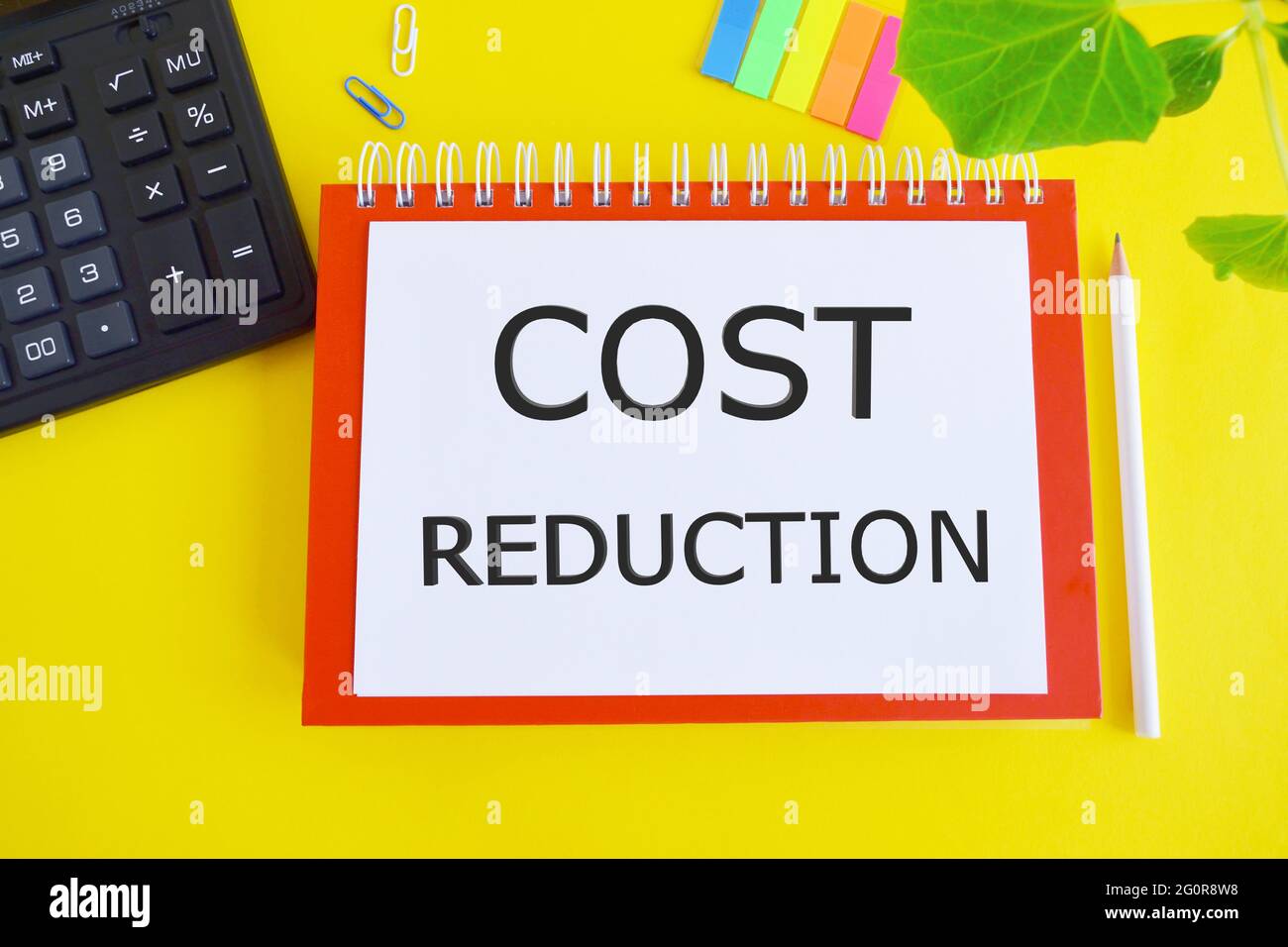 Cost reduction text written on white paper above Notebook, Business ...
