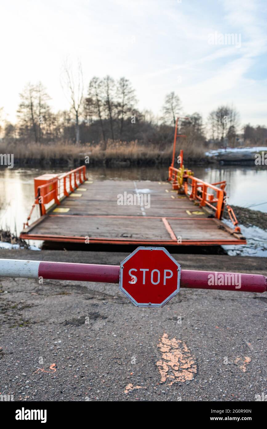 River ferry. STOP sign and barrier before entering the ferry crossing ...