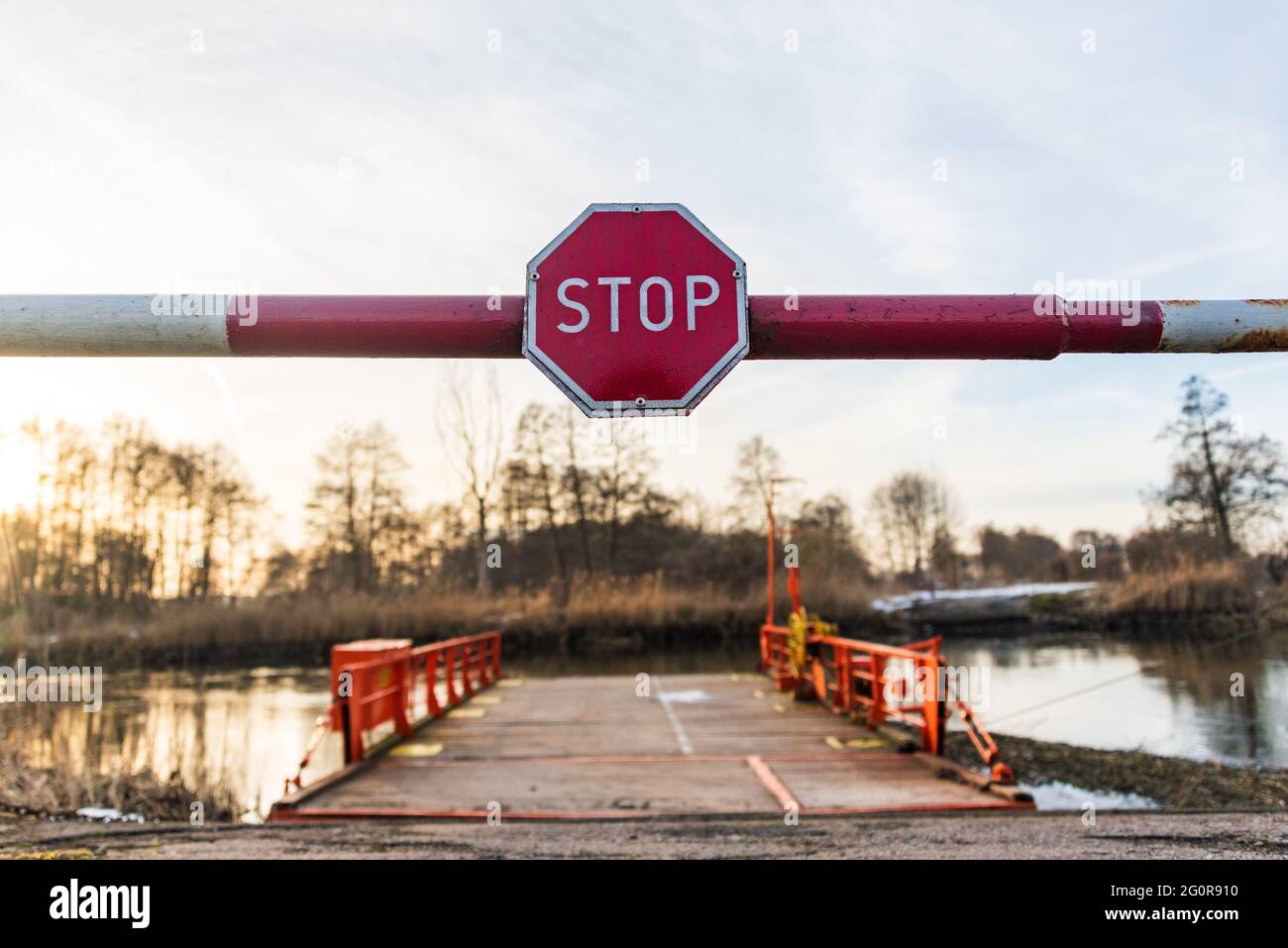 River ferry. STOP sign and barrier before entering the ferry crossing ...