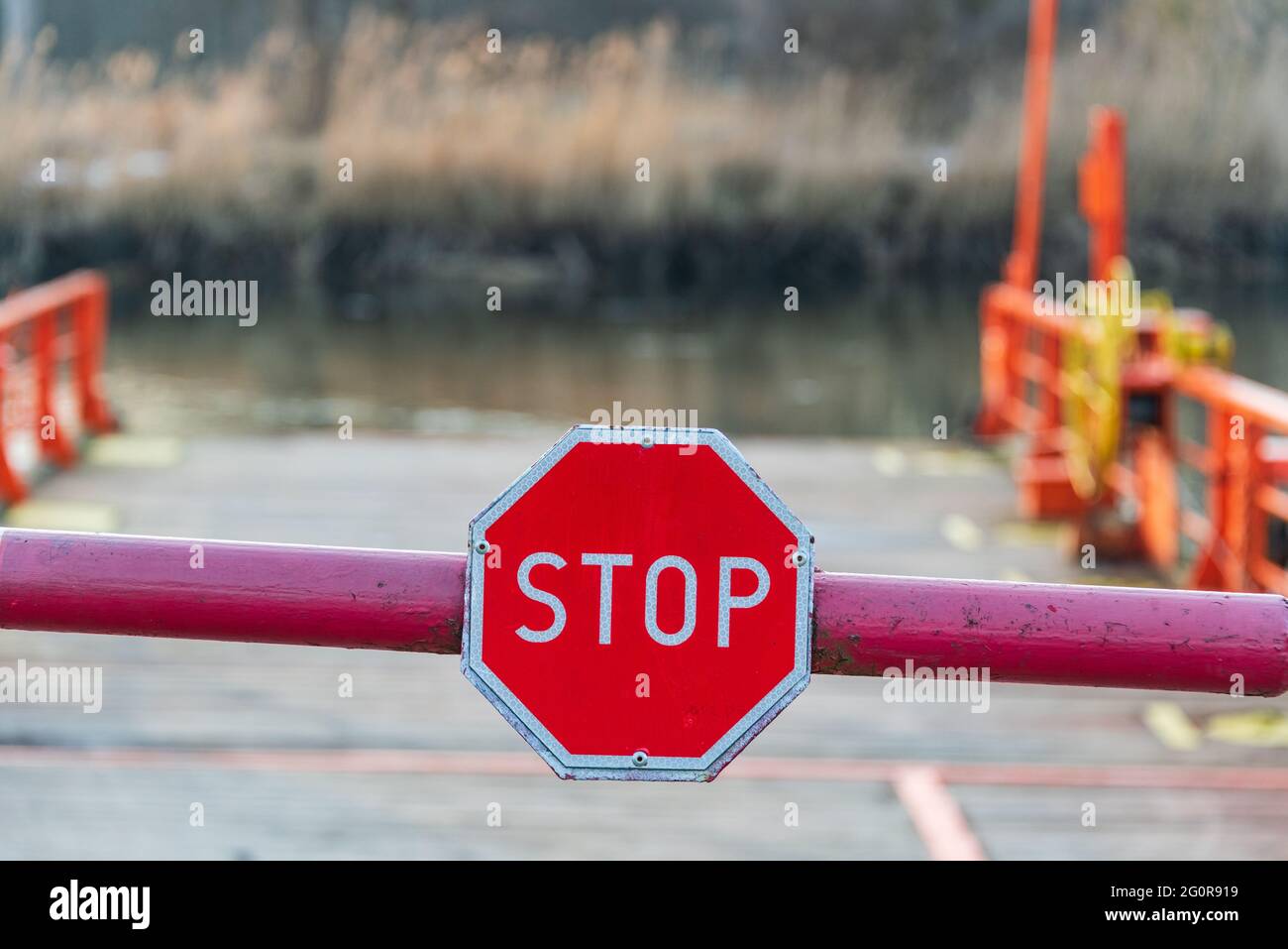 River ferry. STOP sign and barrier before entering the ferry crossing ...