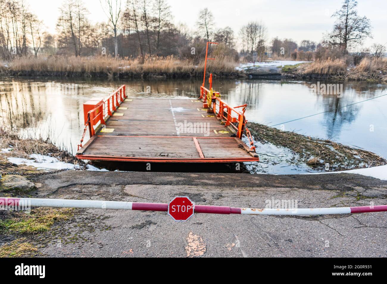 River ferry. STOP sign and barrier before entering the ferry crossing ...