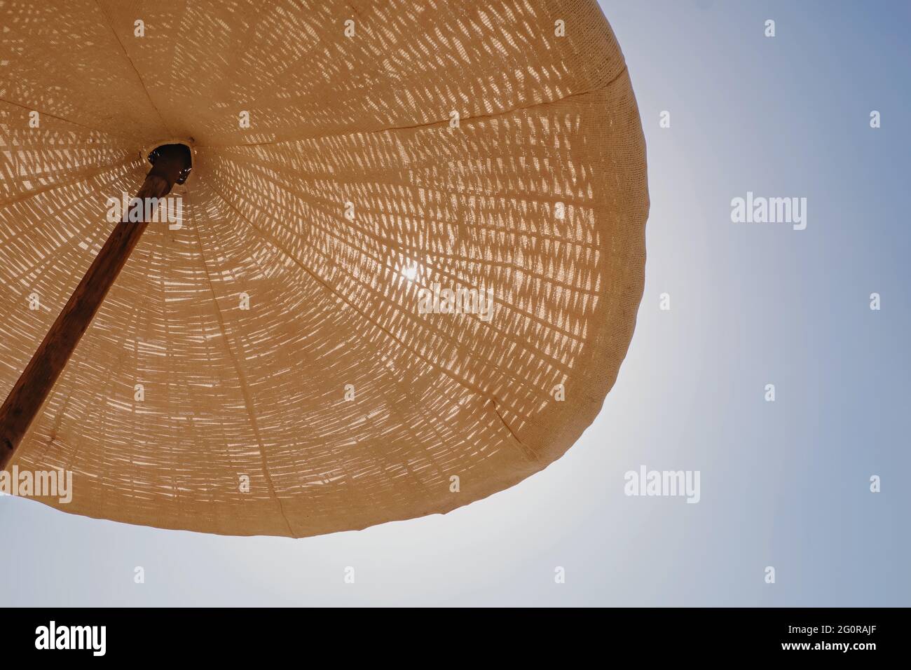 Large umbrella of wicker and cloth Stock Photo - Alamy
