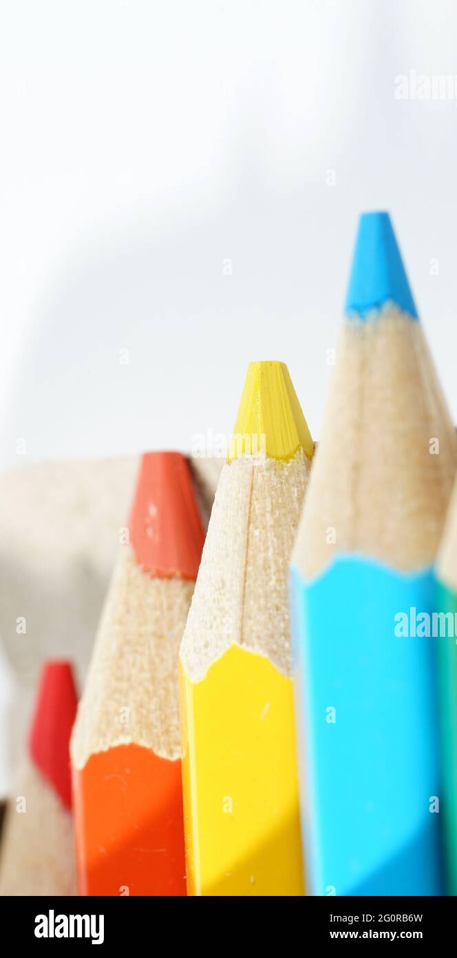 Colorful crayons, pencils with plain paper as a background with ...
