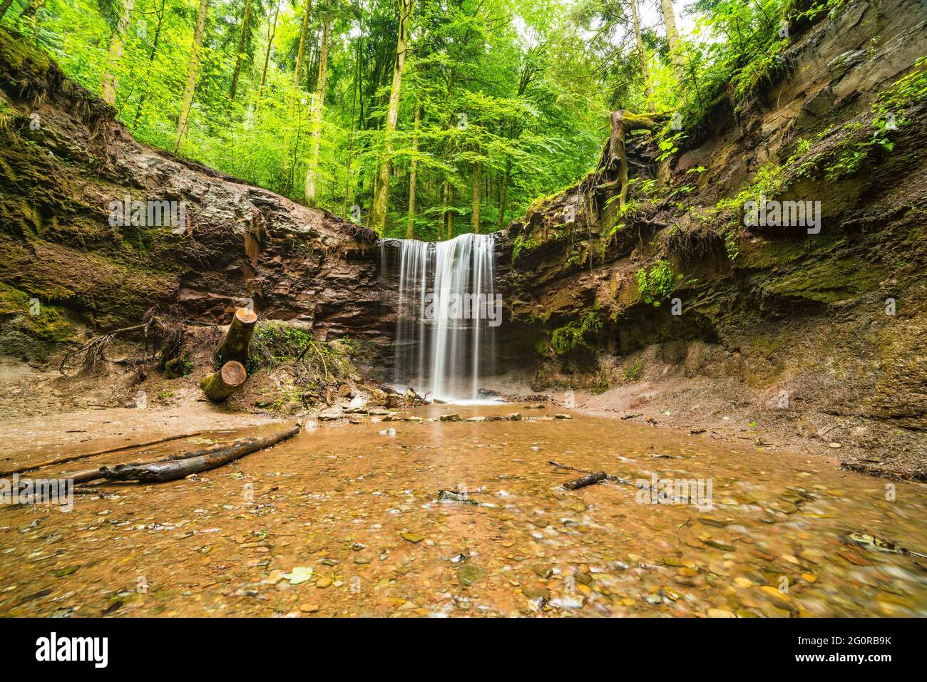 Germany, Beautiful tropical waterfall inside green forest panorama near ...