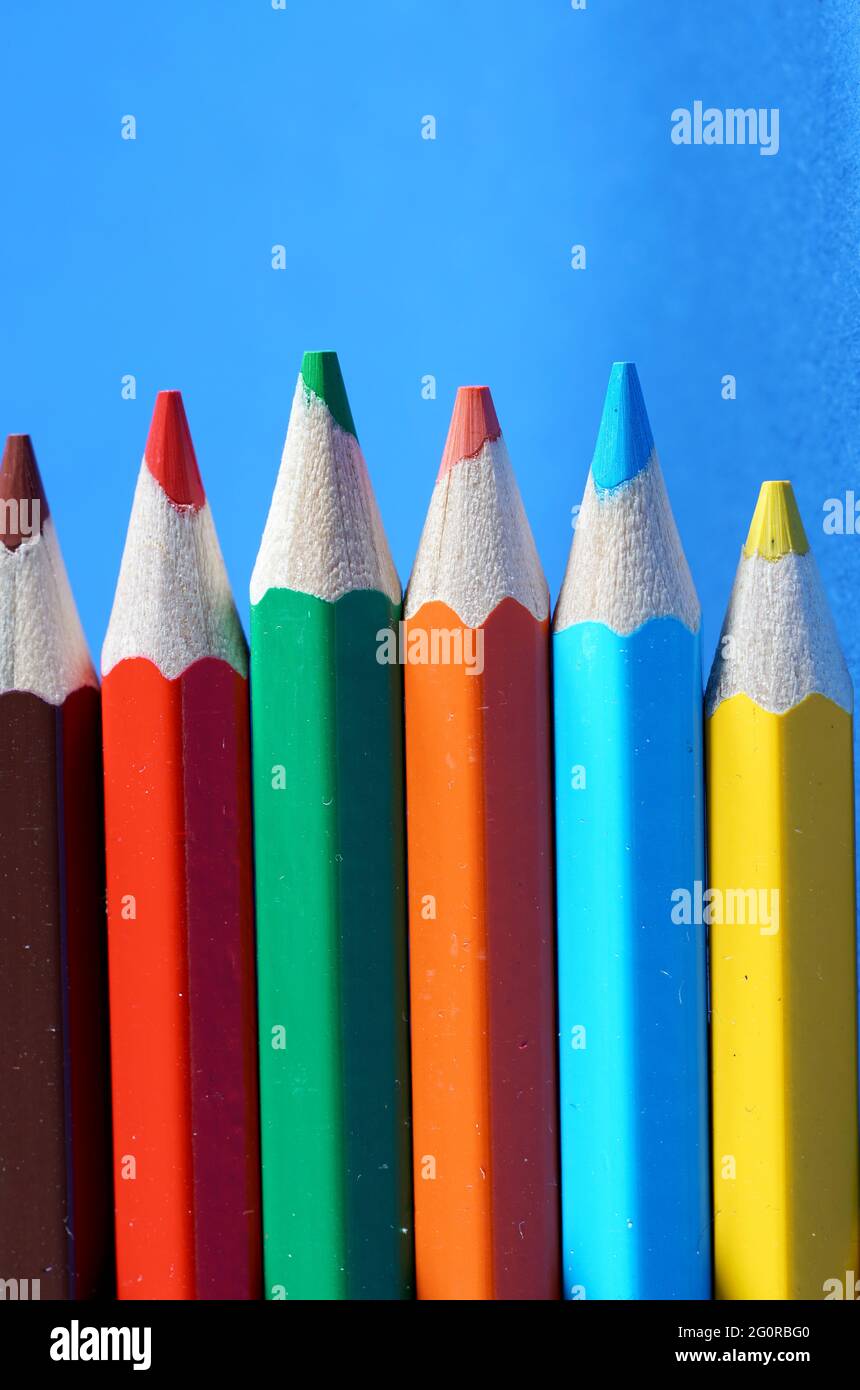 Colorful crayons, pencils with plain paper as a background with ...