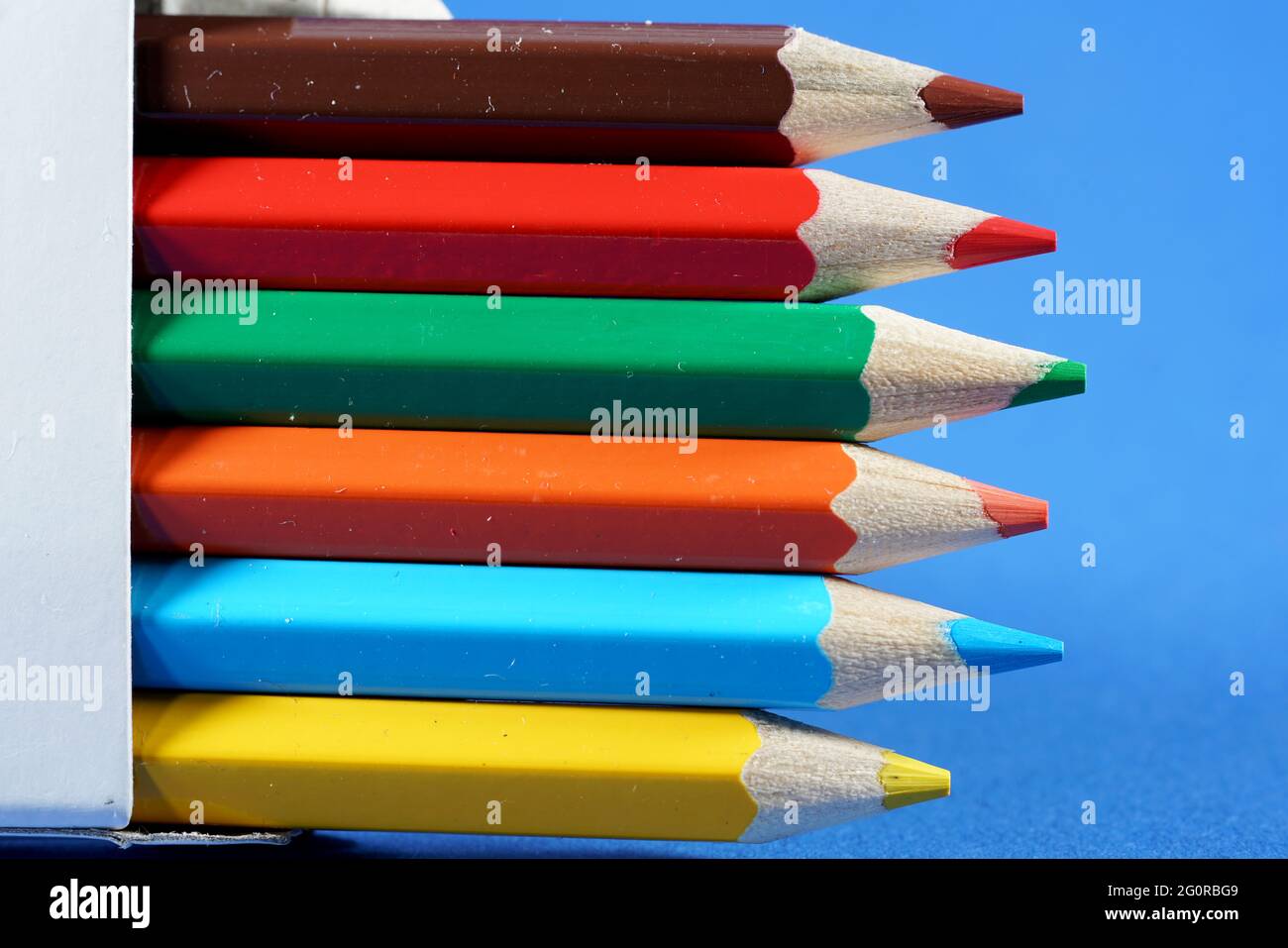 Colorful crayons, pencils with plain paper as a background with ...