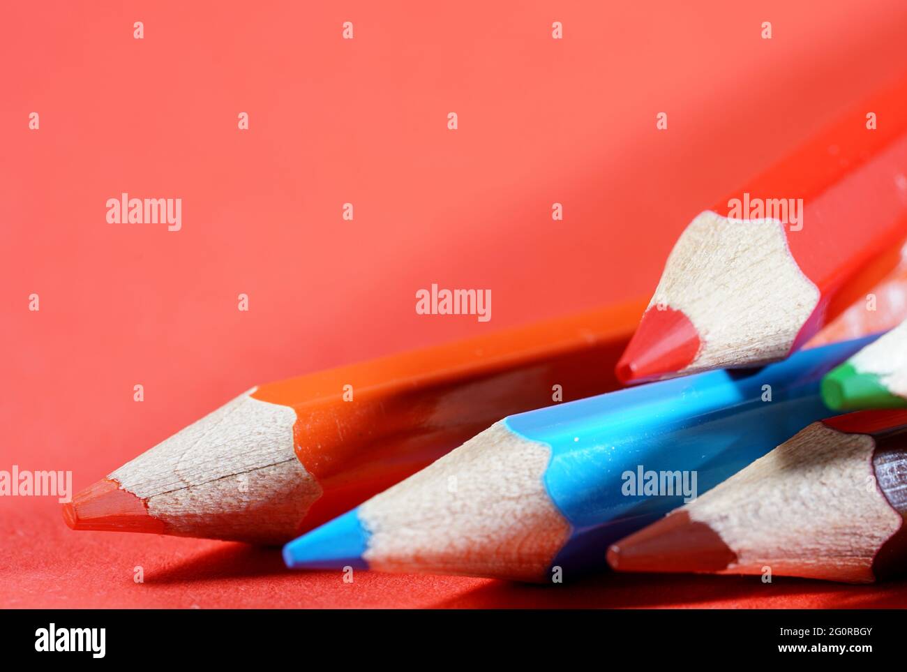 Colorful crayons, pencils with plain paper as a background with ...