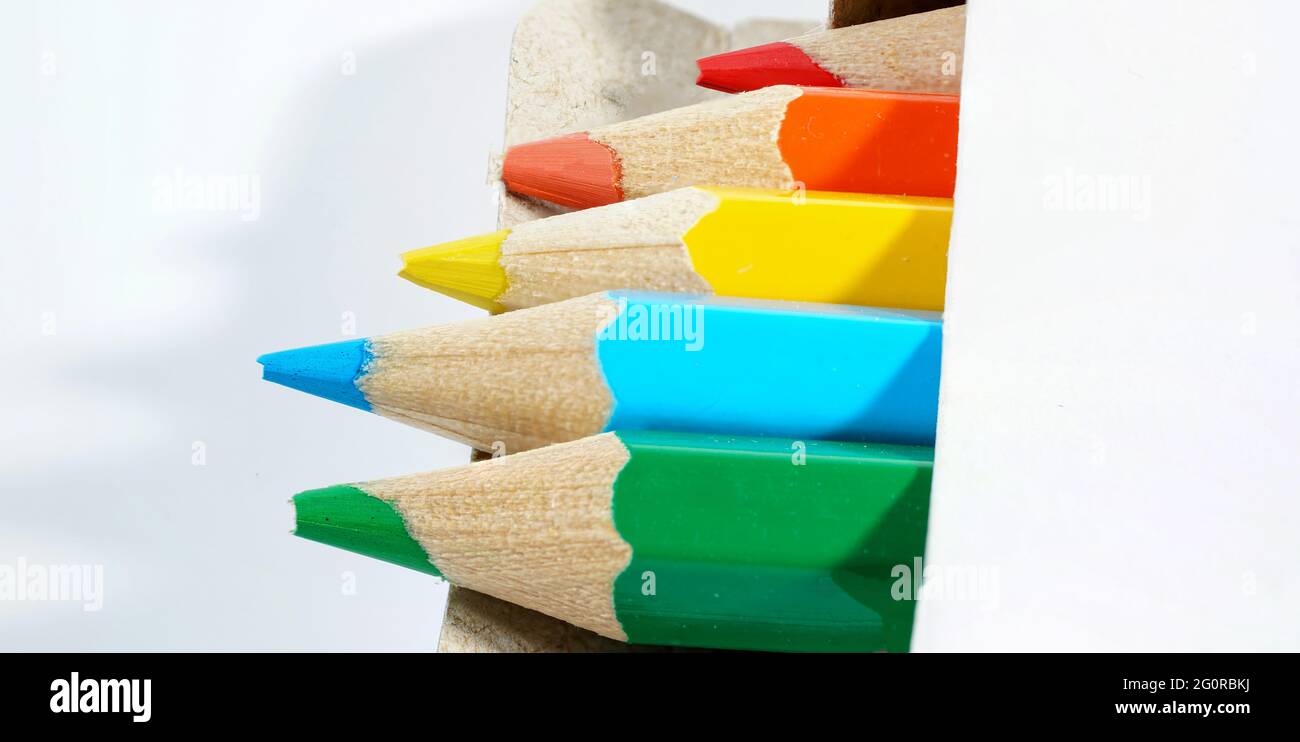 Colorful crayons, pencils with plain paper as a background with ...