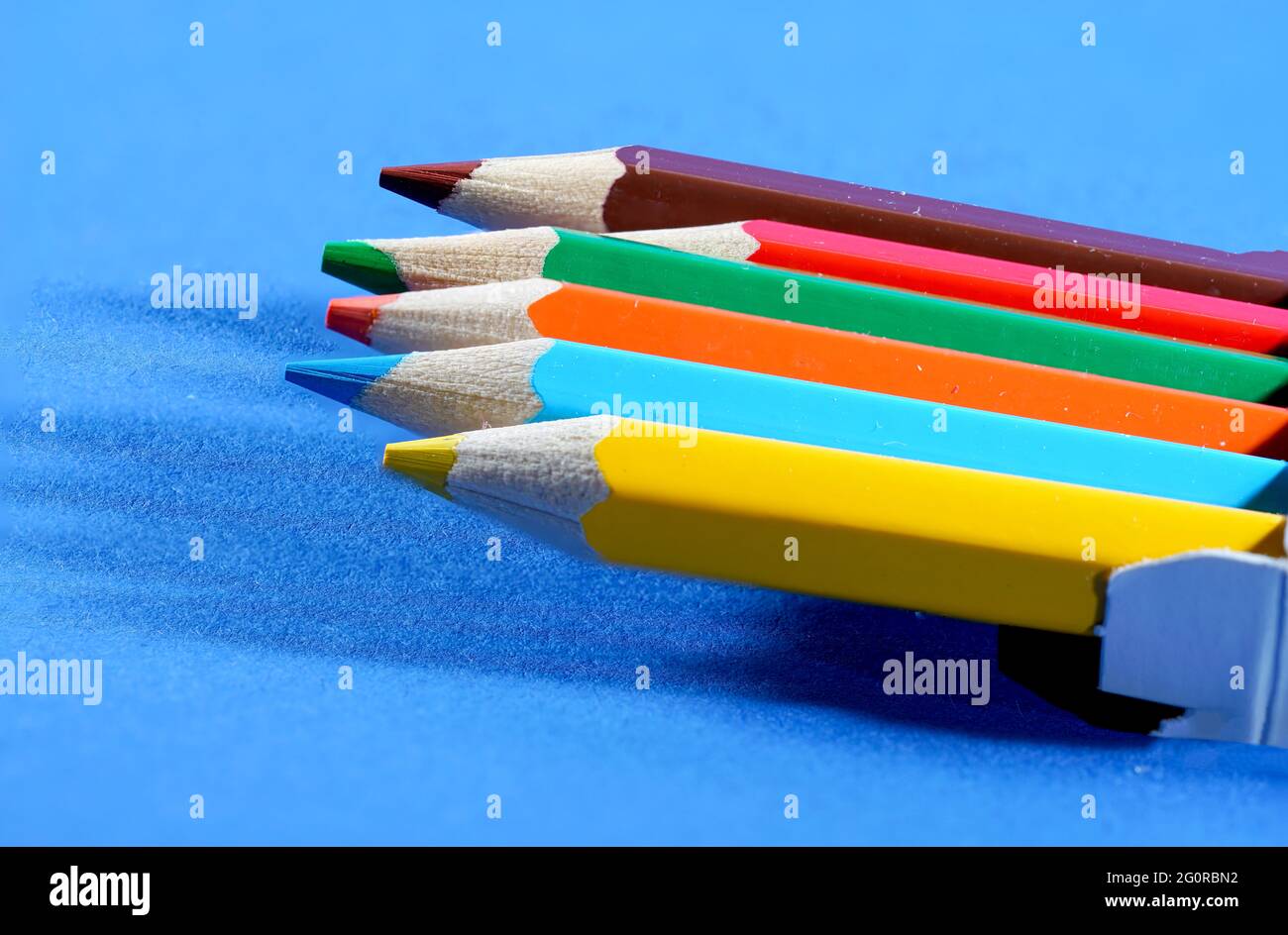 Colorful crayons, pencils with plain paper as a background with ...