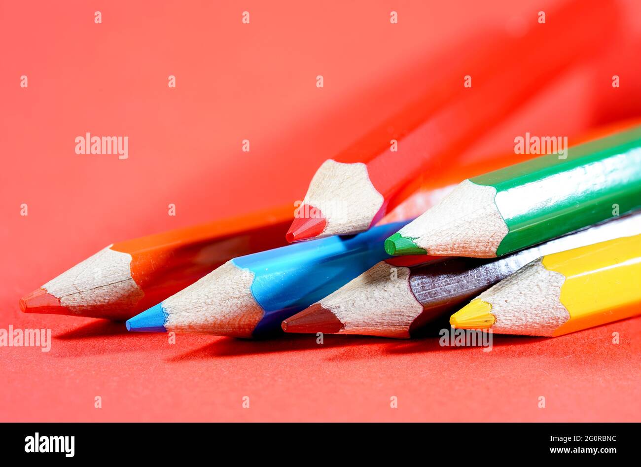Colorful crayons, pencils with plain paper as a background with ...