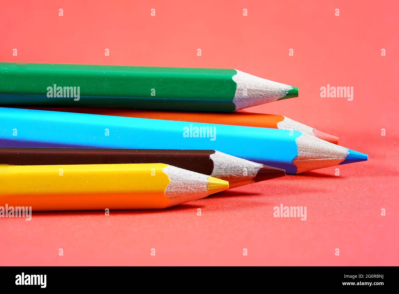 Colorful crayons, pencils with plain paper as a background with ...