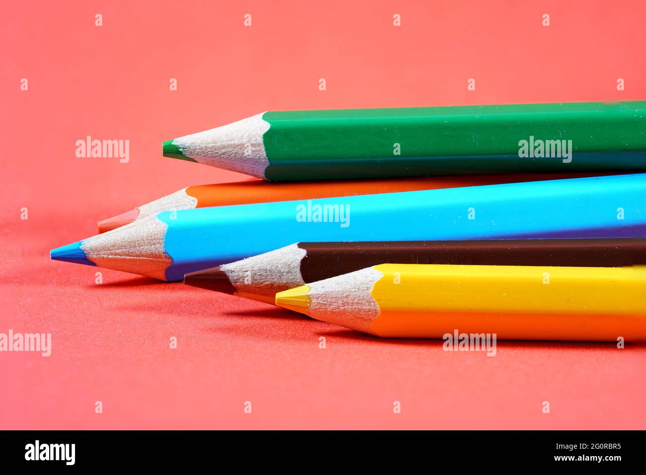 Colorful crayons, pencils with plain paper as a background with ...
