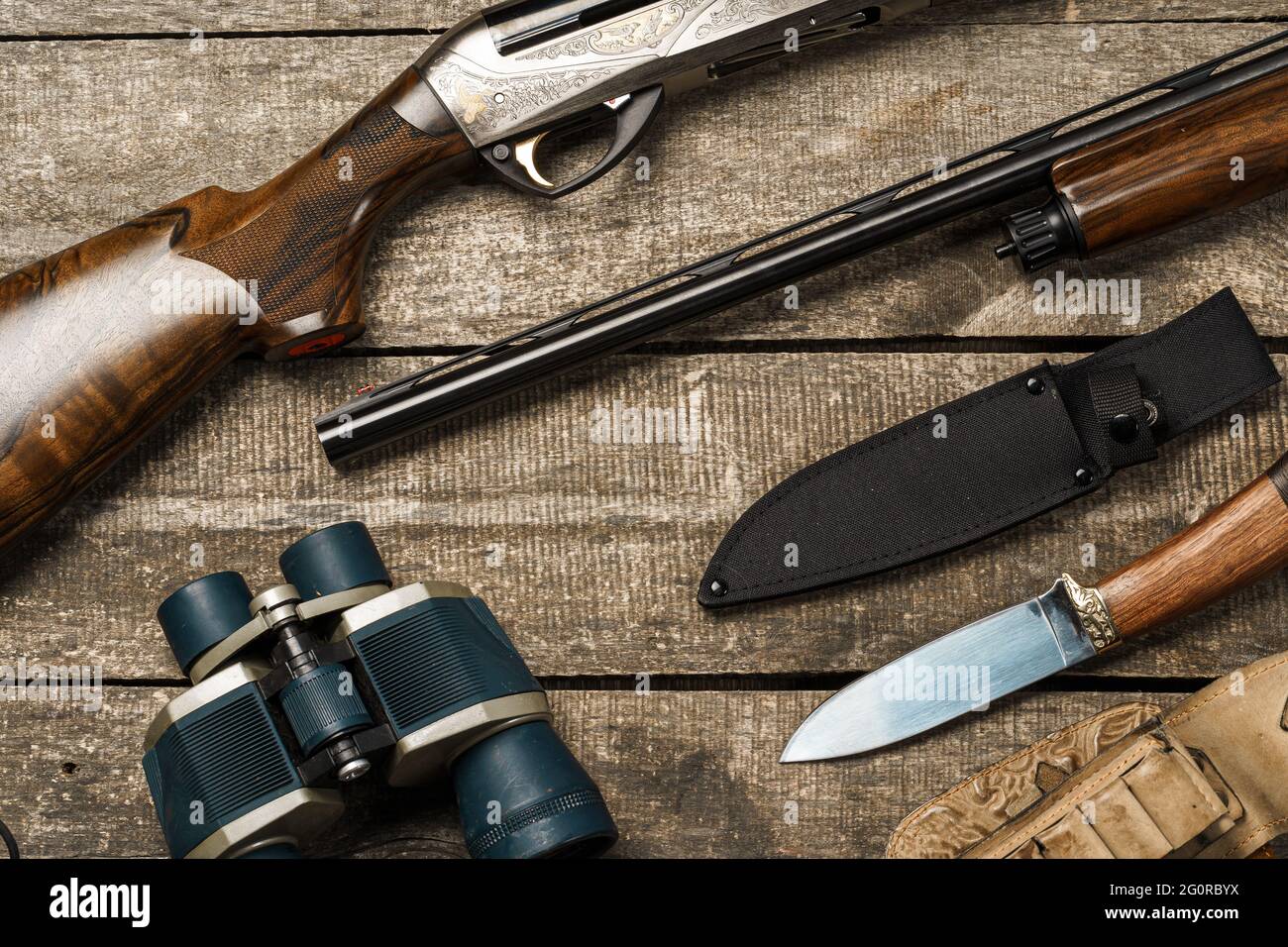 Hunting equipment on old wooden background including rifle, knife ...