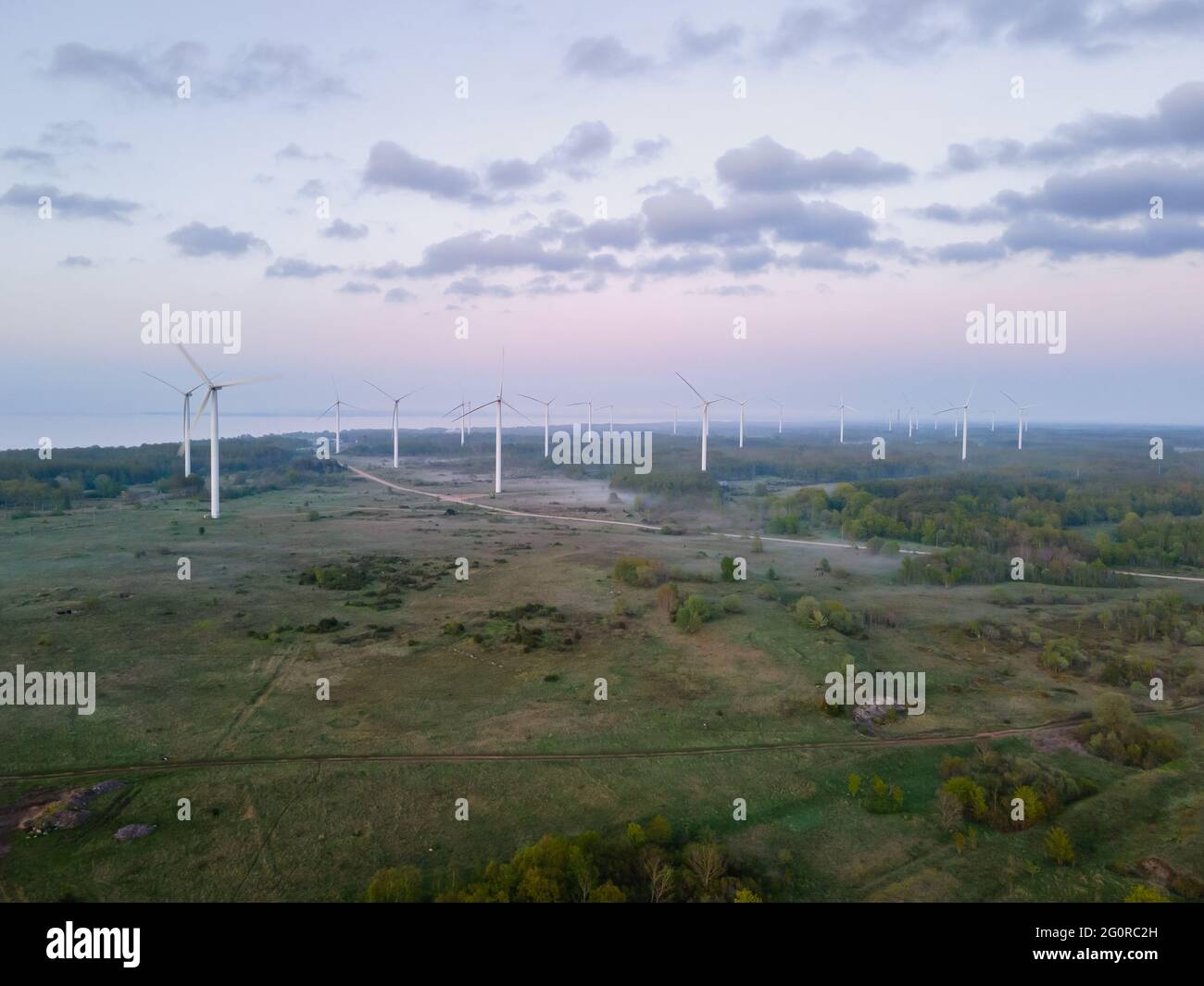 Wind turbines on sunset at summer evening. Renewable energy Stock Photo ...