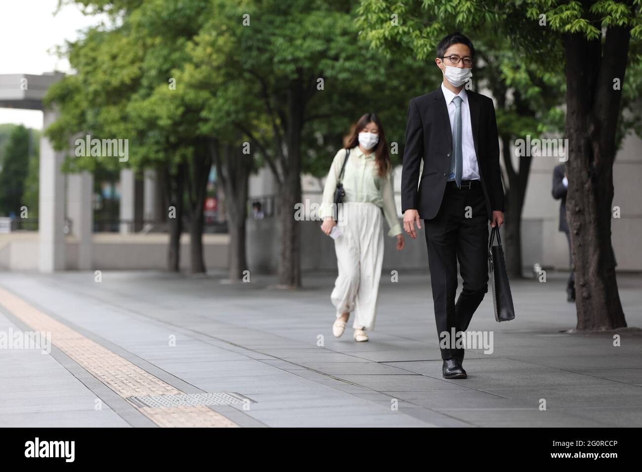 Tokyo, Japan. 02nd June, 2021. Pedestrians wearing face masks as a ...