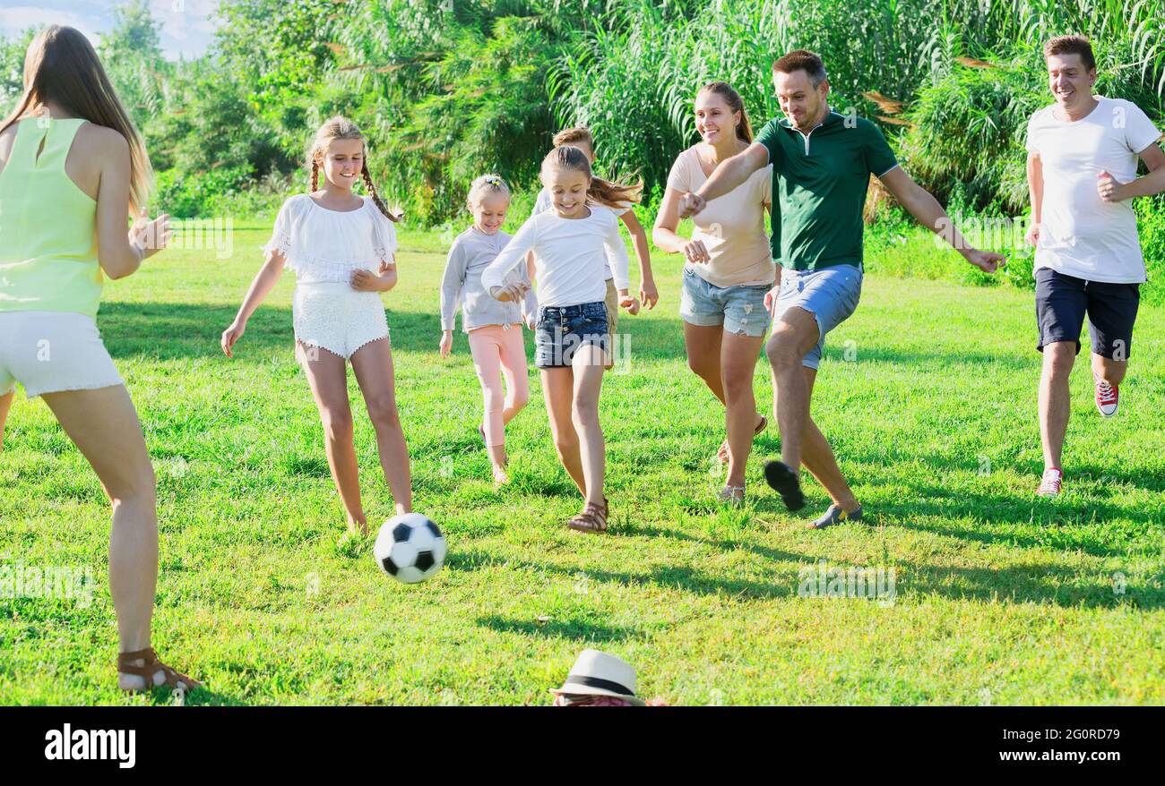 People with kids having fun together playing football Stock Photo - Alamy