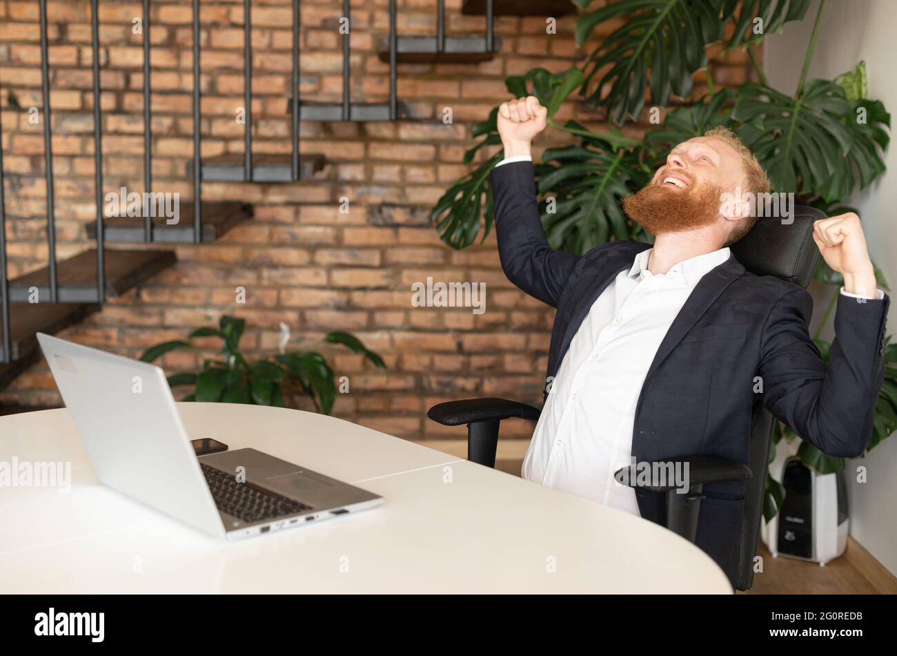 Overjoyed Red Hair Male Office Employee With Open Mouth Screaming Yes