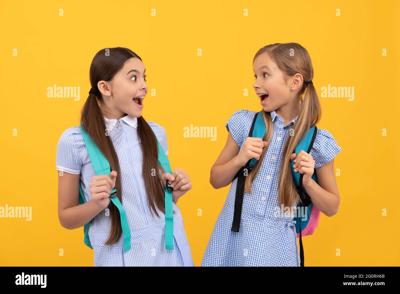 Surprised school friends on September 1 yellow background, friendship ...